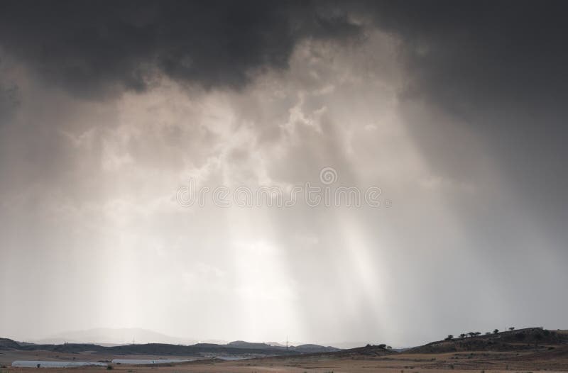 Bright Sun Rays Light Shining through Dark Clouds Over Mountain at ...