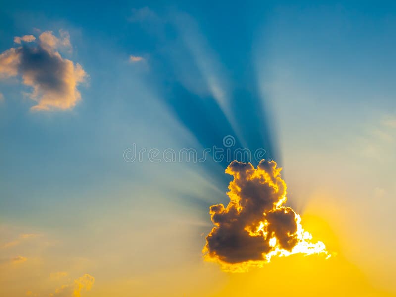 Sun Rays from the Evening Sun Behind Small Cloud Stock Photo - Image of ...