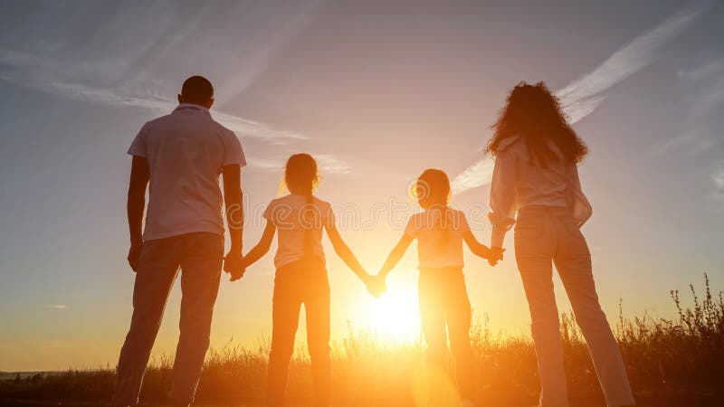 Sun Rays Fall on Family Holding Hands in Field at Sunset Stock Image ...