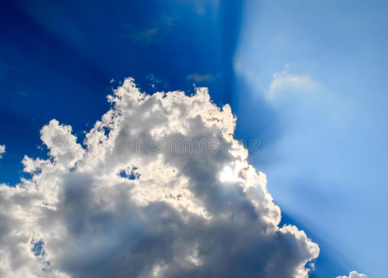 Sun Rays Gleaming through Clouds with Dark Blue Sky Stock Photo - Image ...