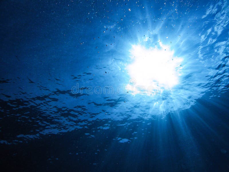 Sun Rays Going Deep through the Clear Blue Water Stock Image - Image of ...
