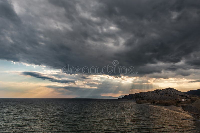 Sun Rays Passing through the Clouds Over the Sea Stock Photo - Image of ...