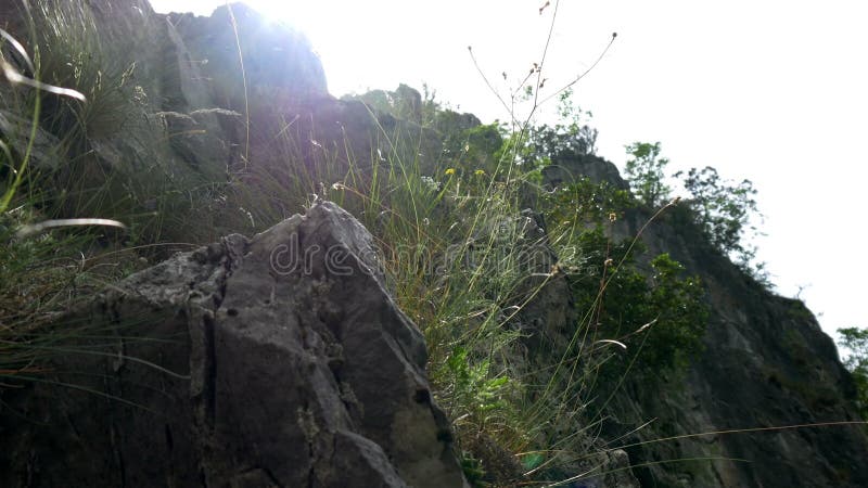 Sun rays through rocks stock footage. Video of hill - 186107422