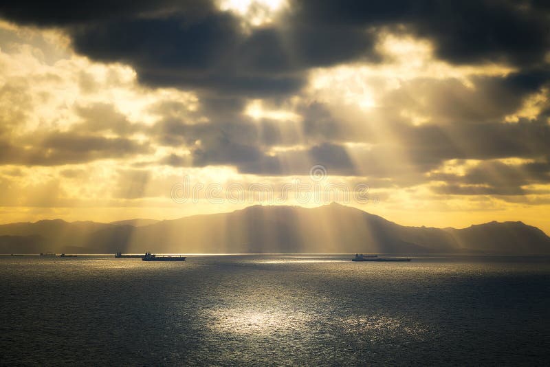 Sun rays on sea with ships stock photo. Image of container - 87978050