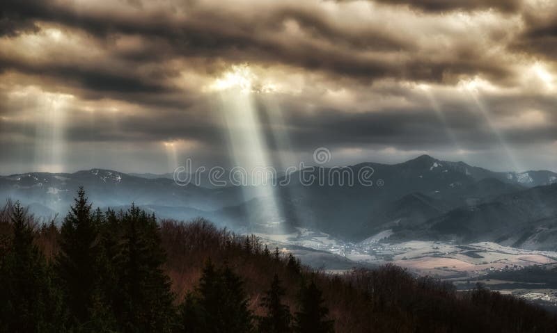 Sun Rays Shining through Dark Clouds on the Hills Stock Image - Image ...