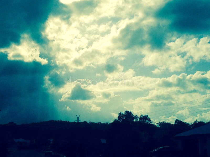 Sun Rays Shining Through Dark Clouds Stock Photo - Image of blue ...