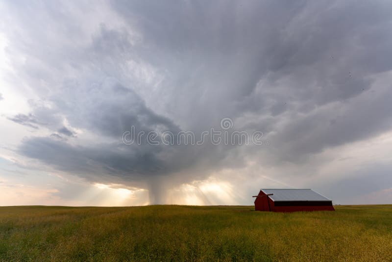 Dramatic Rain Shower Passing Over a Red Barn in the Prairie Stock Photo ...