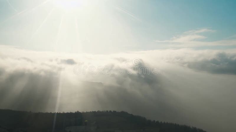 Sun Rays Shining through a Thick Layer of Clouds Above a Mountain ...
