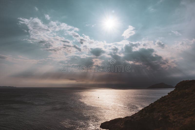 Sun Rays Shining Though Clouds Over Sea in Greece Stock Image - Image ...