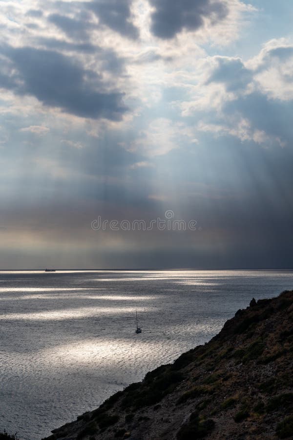 Sun Rays Shining Though Clouds Over Sea in Greece Stock Image - Image ...