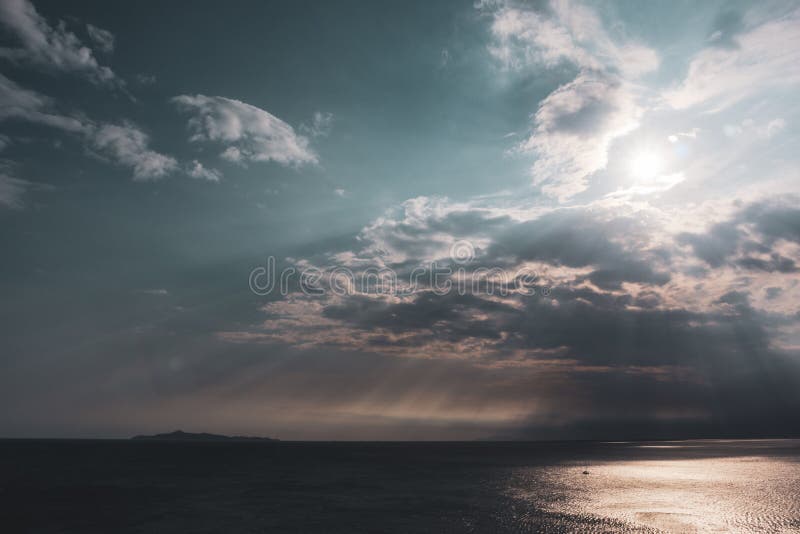 Sun Rays Shining Though Clouds Over Sea in Greece Stock Image - Image ...