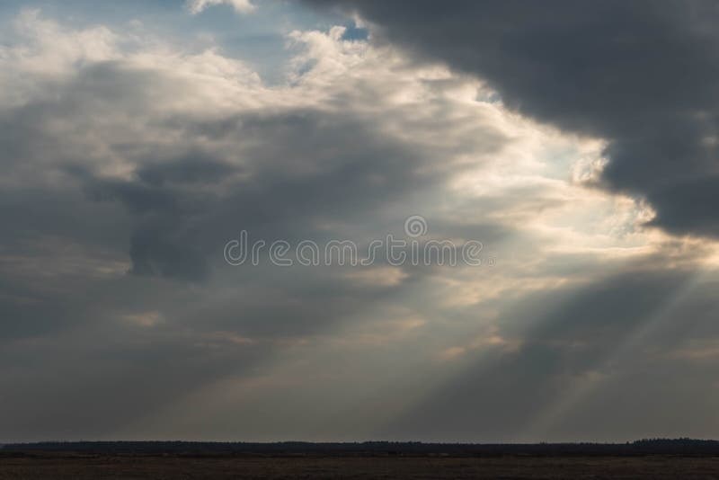 Sun Rays Streaming Down the Streaks of Dark Clouds Stock Photo - Image ...