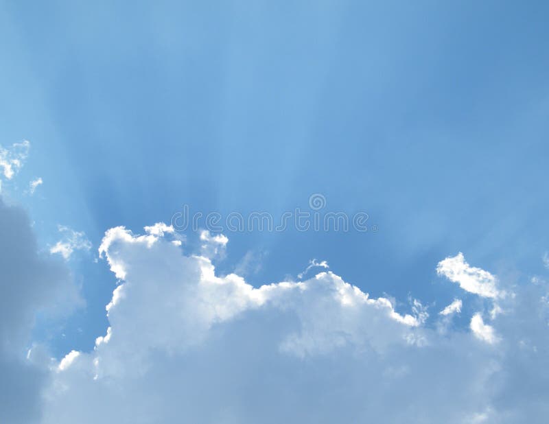 Sun Rays Streaming Past Puffy White Clouds in Sky Stock Image - Image ...