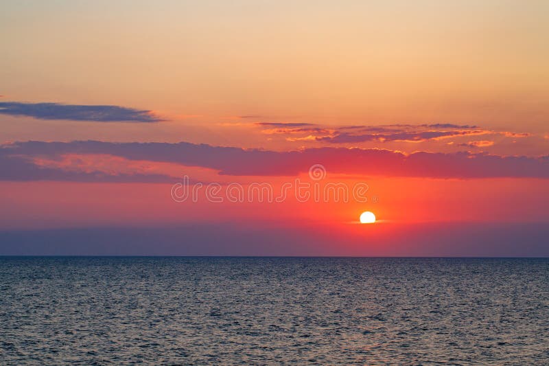 Sun Red Sunset Setting Behind Clouds on Horizon Over Sea Stock Image ...