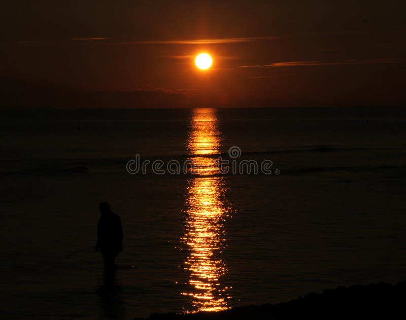 The Sun is Reflected Over a Calm Sea at Sunset Stock Photo - Image of ...