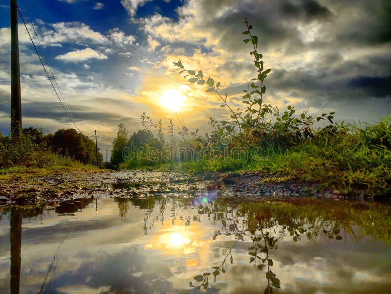 Sun reflected in a puddle stock image. Image of skyline - 79118143