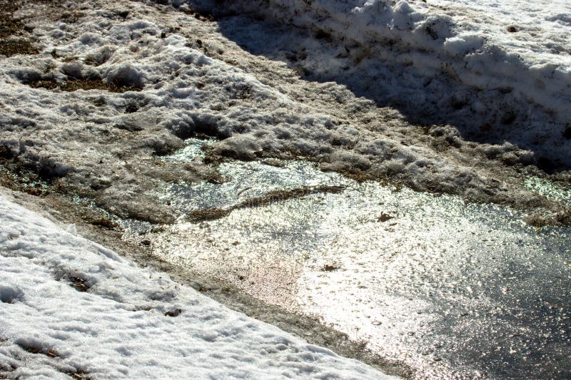 The Sun Reflected in a Slushy Puddle of Water Stock Photo - Image of ...