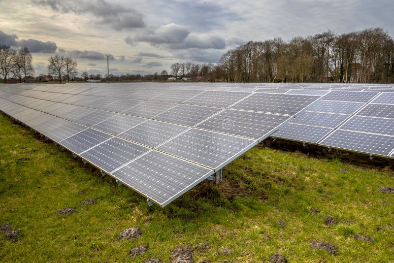 Sun Reflecting in Solar Panels in Meadow Stock Photo - Image of ...