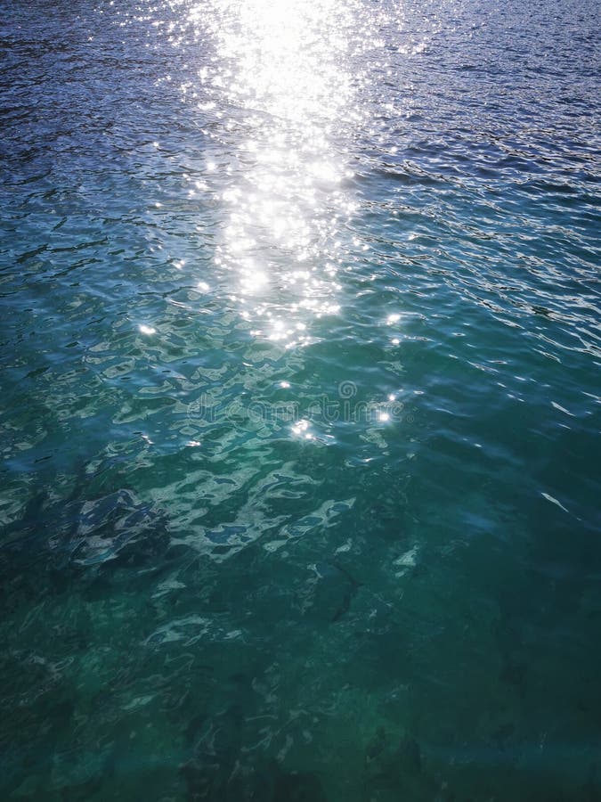 Sun Reflection in a Clear Blue Sea Stock Photo - Image of wave, clear ...