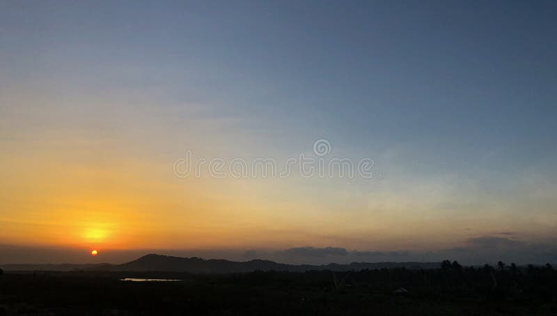 The Sun Rises from Behind the Hill Stock Image - Image of foreground ...