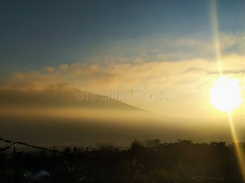 The Sun Rises from Behind the Mountains Stock Photo - Image of sunrise ...