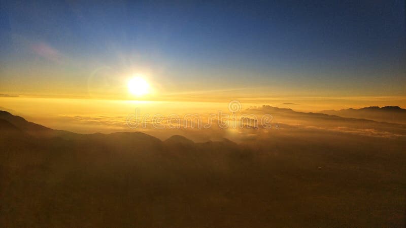 The Sun Rises in the Clouds on the Top of Mount Burni Telong Stock ...