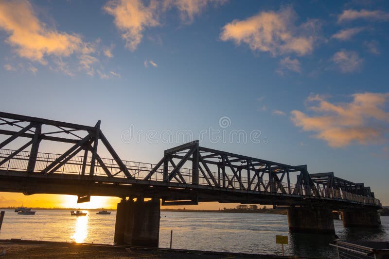 Sun Rises on Horizon Under Tauraga Railway Bridge Stock Photo - Image ...