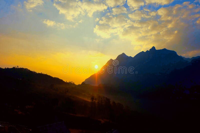 The Sun Rises from the Mountain Horizon and Glows Yellow. Stock Image ...