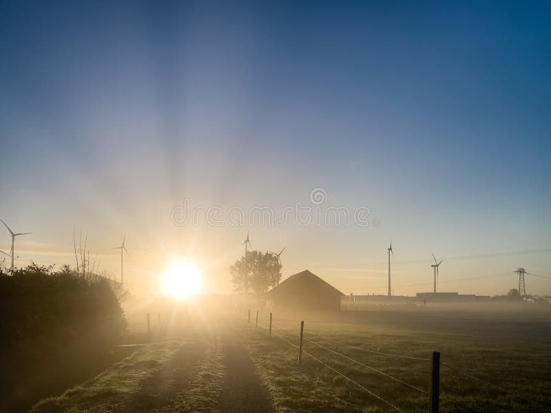 The Sun Rises Over a Misty Landscape Stock Photo - Image of nature ...