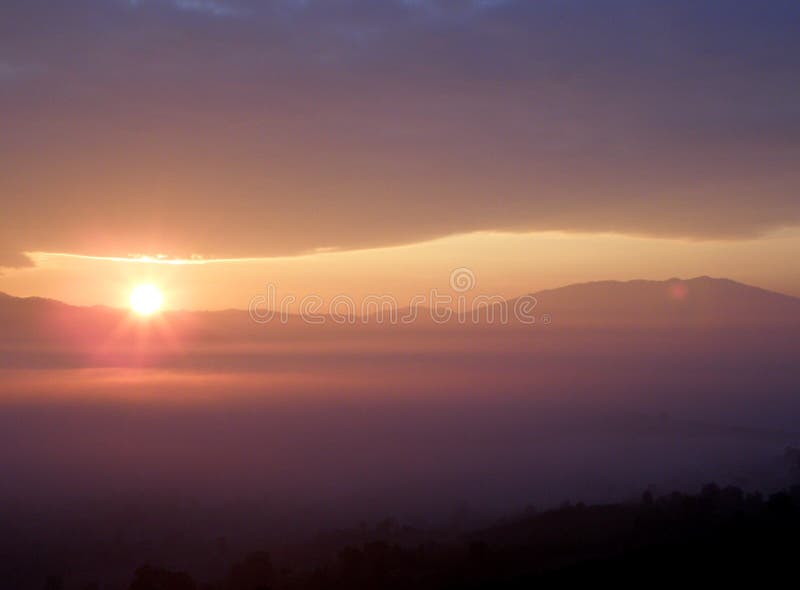 The Sun Rising on Beautiful Orange and Purple Gradation Cloudy Sky ...
