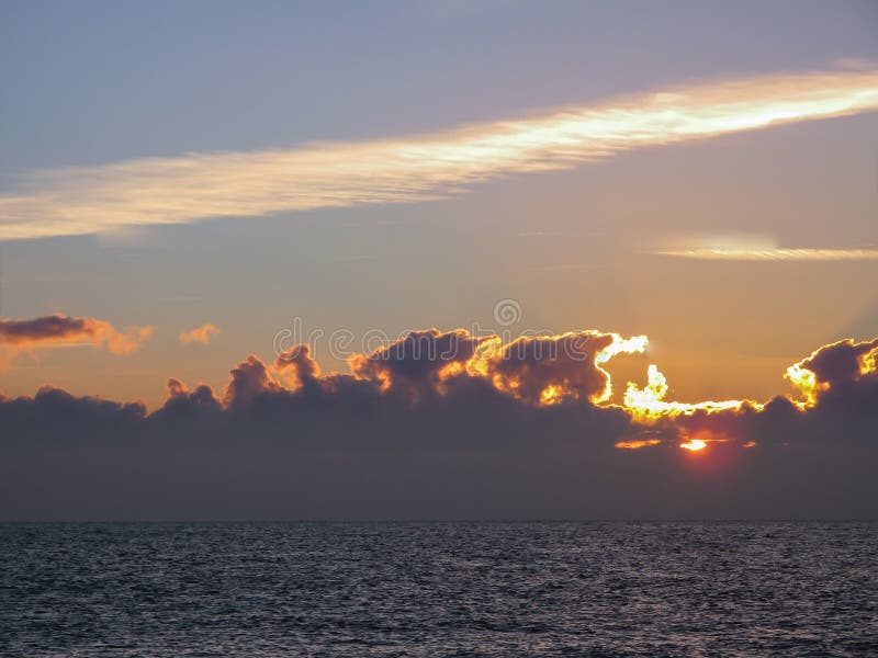 Sun Rising Behind Clouds on the Cornwall Coast Stock Photo - Image of ...