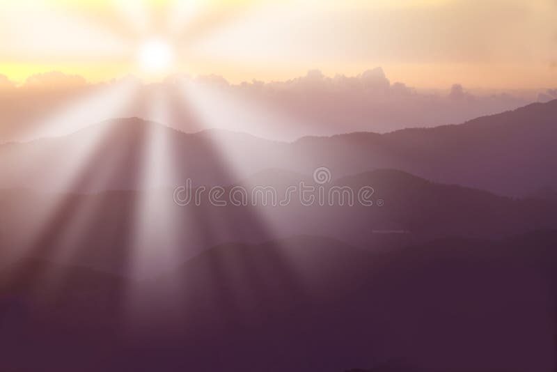 Sun Rising Behind Mountains in Summer. Sun Rays Causing Lensflare Over ...