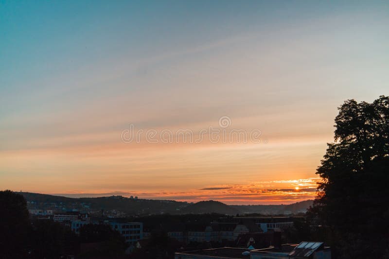 Sun Rising through the Clouds on the Horizon Stock Image - Image of ...