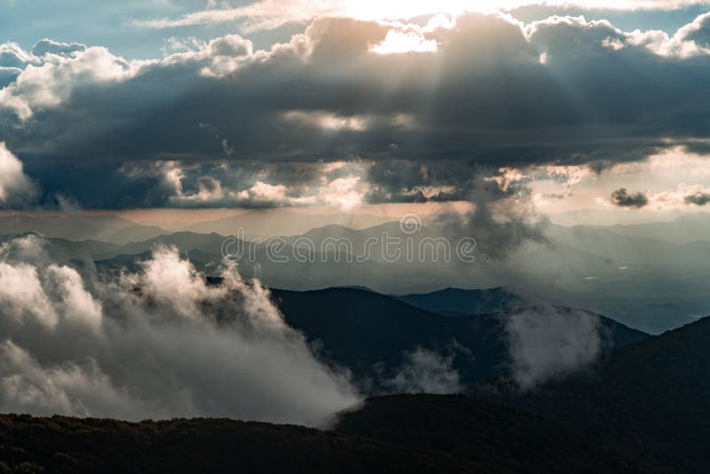 Sun Rising with Clouds in the Sky Over Hills in a Beautiful Valley ...