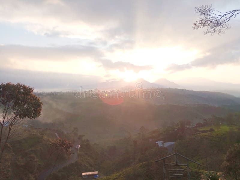 The Sun Rising from the Mountains Illuminates Village Stock Photo ...