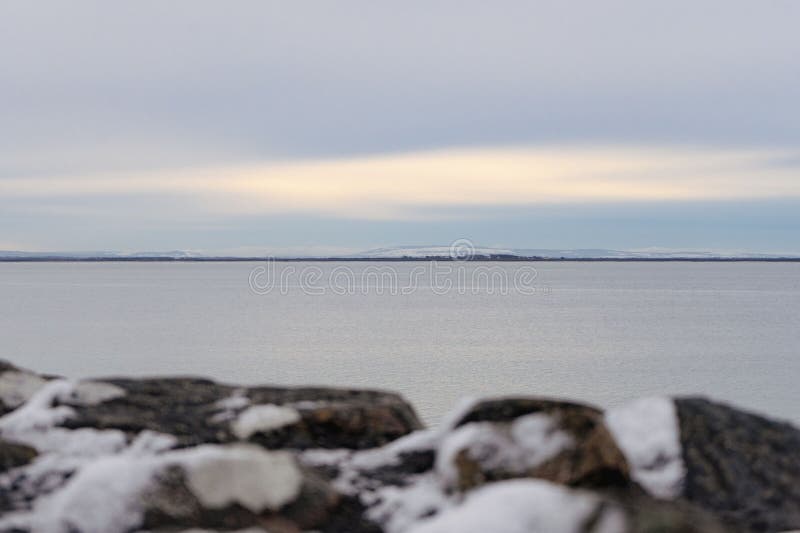 Sun Rising Over the Ocean with Snow in the Foreground. Stock Image ...