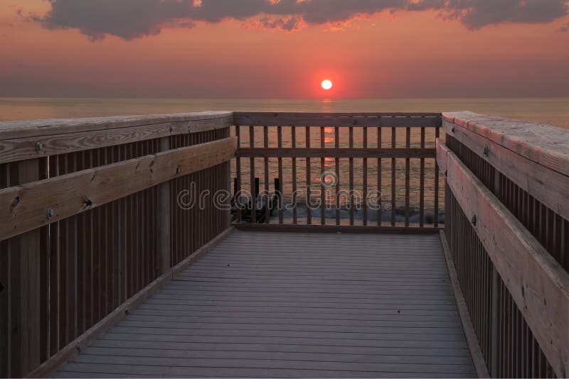 Sun Rising Over a Railing at the Beach Stock Image - Image of horizon ...