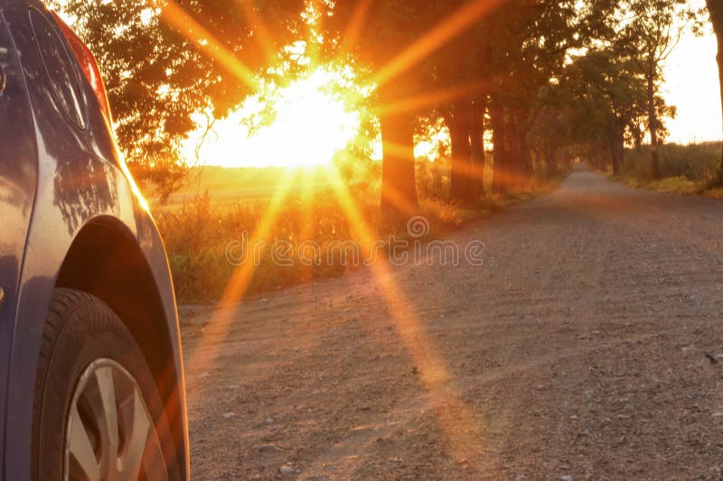 The Sun`s Rays Blue Cars on the Road, the Sunset and the Car Stock ...