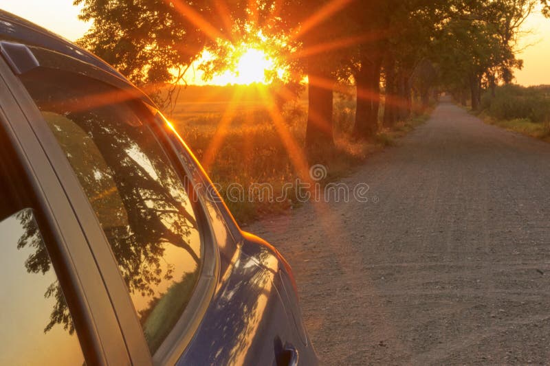The Sun`s Rays Blue Cars on the Road, the Sunset and the Car Stock ...