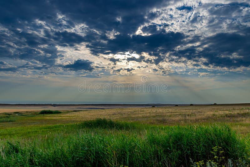 The Sun`s Rays Break through the Clouds on the Ground. Green Grass ...