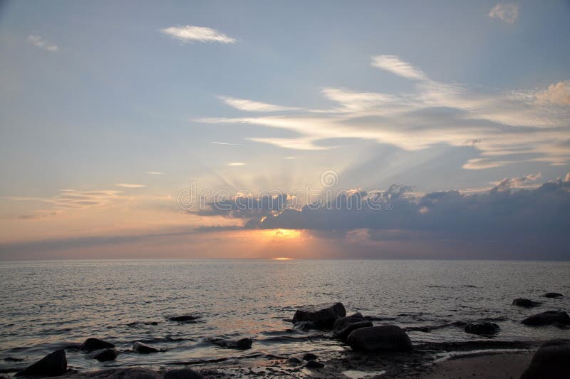 The Sun`s Rays through the Clouds Above the Sea. Stock Image - Image of ...