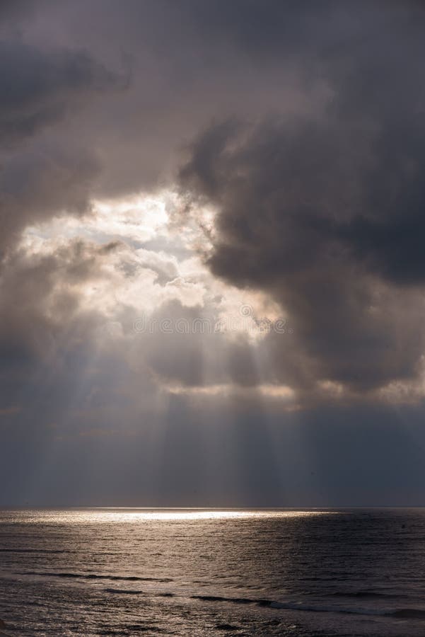 The Sun S Rays Passing through the Storm Clouds Over the Sea Stock ...