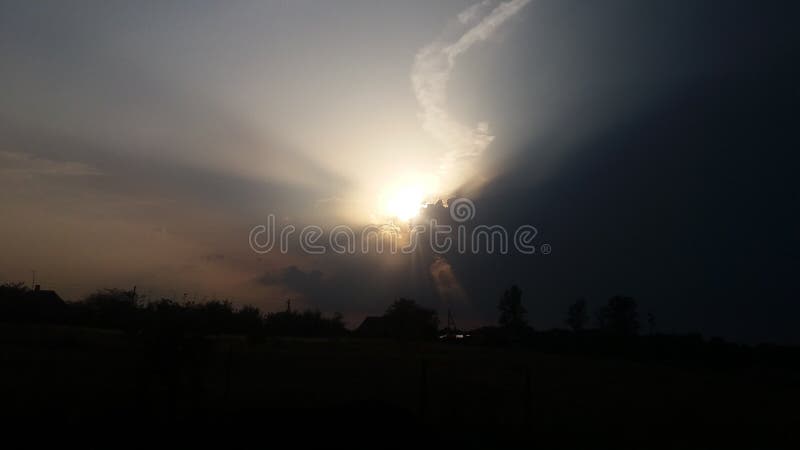 The Sun S Rays Shine from Behind the Clouds Stock Photo - Image of ...