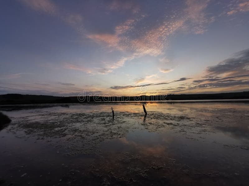 Sun set over the lake stock photo. Image of cloud, coast - 247512736