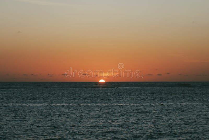The Sun Sets Behind the Beach Water Stock Photo - Image of sets, water ...