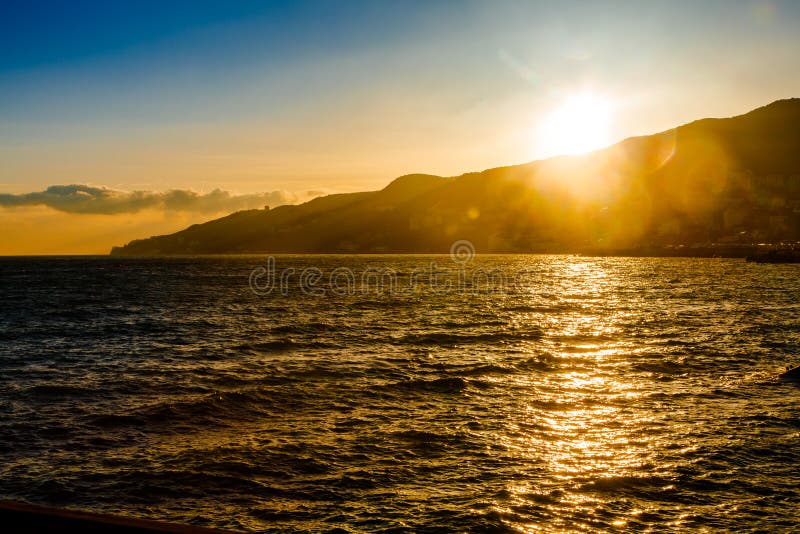The Sun Sets Behind the Mountain Stock Photo - Image of beautiful ...