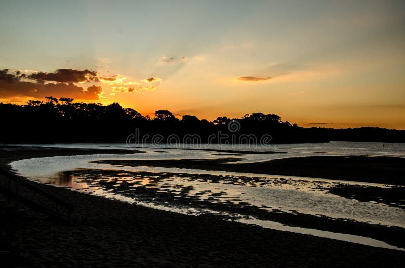 The Sun Sets on the Low Tide of the Beach Stock Photo - Image of beach ...