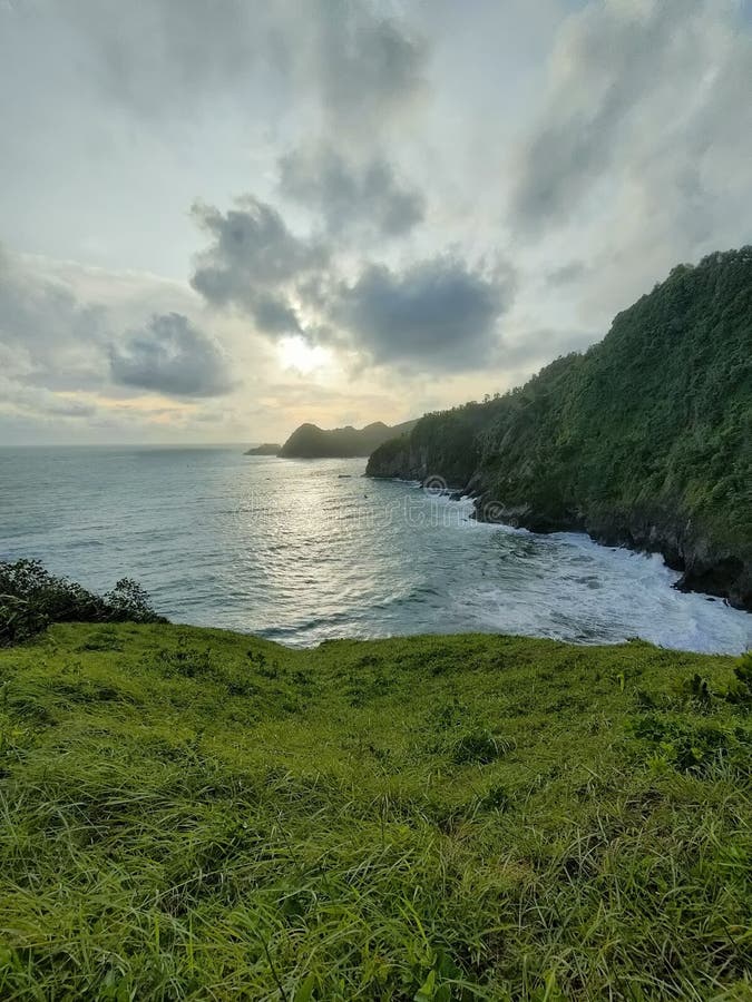 The Sun Sets in the Meadow Under a High Hill Stock Image - Image of ...