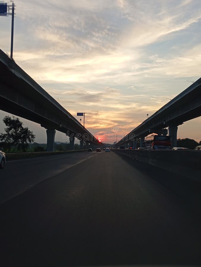 The Sun Sets in the Western Sky Stock Image - Image of flyovers, road ...