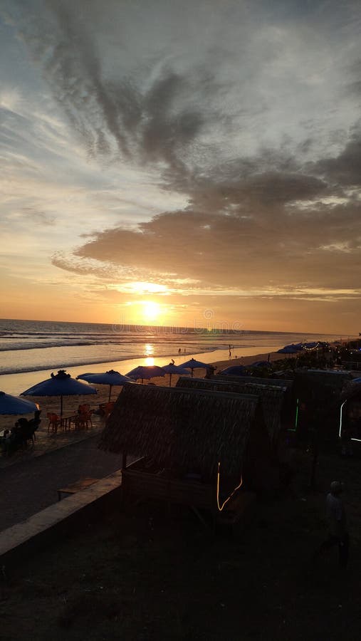 The Sun is almost Setting on the Beach with an Orange Sky Stock Photo ...